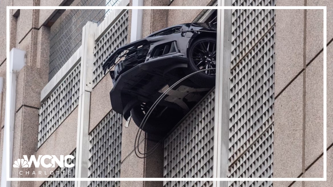 Car dangles out of parking deck | wcnc.com